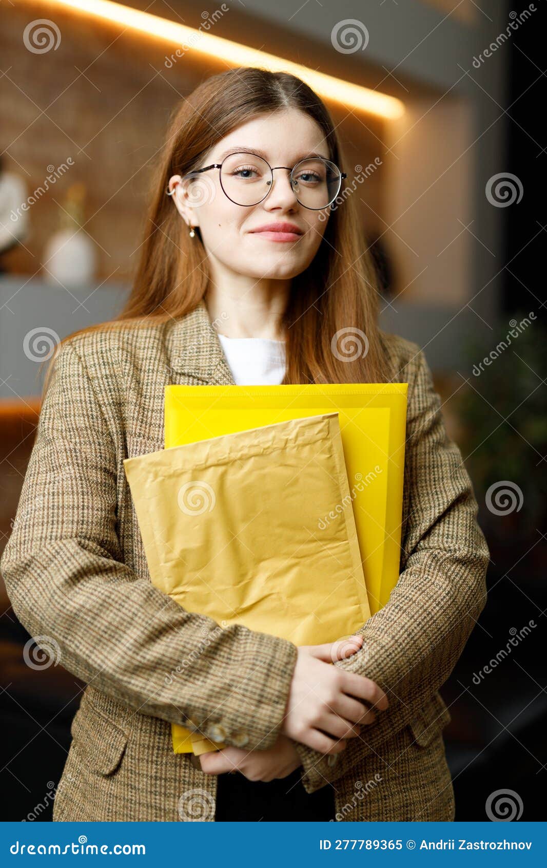 Young Woman Employee Trainee in a Jacket with Folders in Her Hands ...