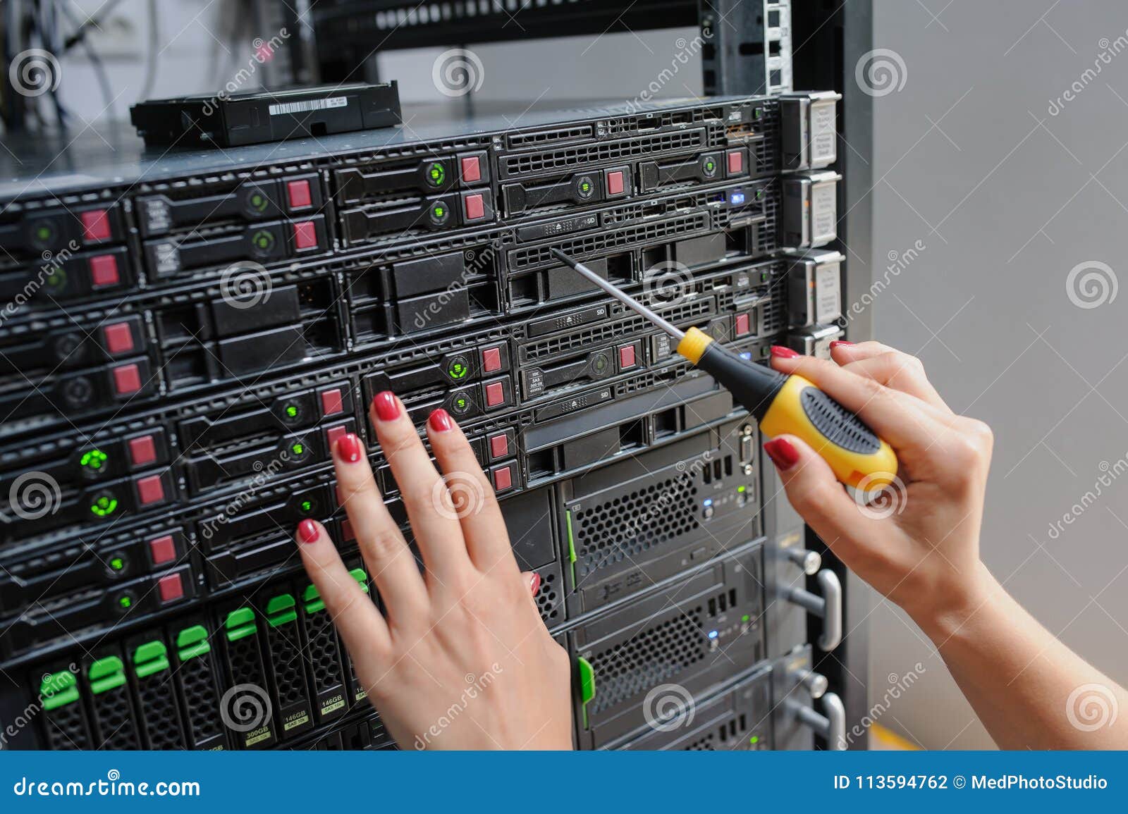 Young Woman Engineer it with a Screwdriver between the Server Ra Stock ...