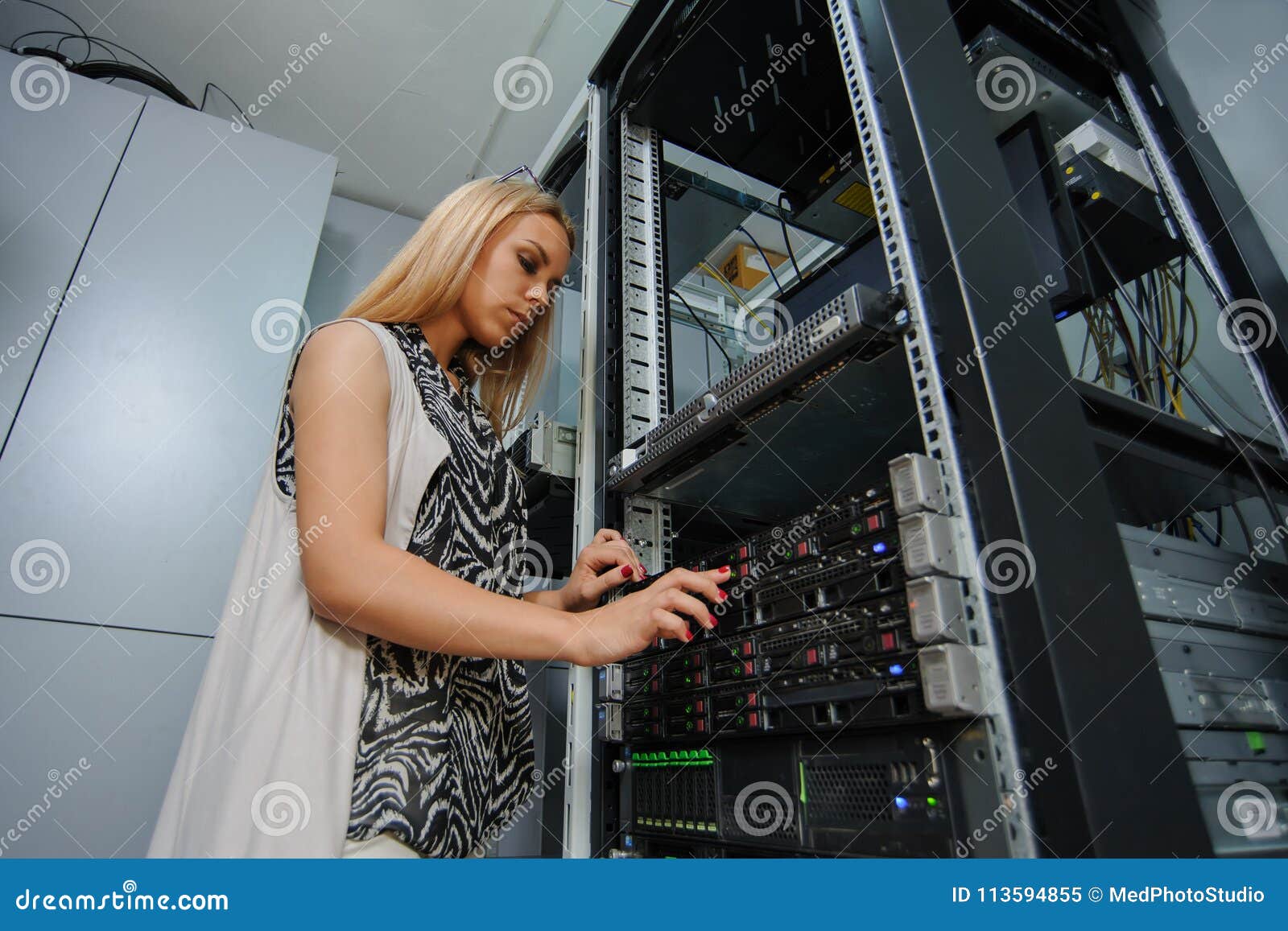 Young Woman Engineer it between the Server Racks in the Data Ce Stock ...