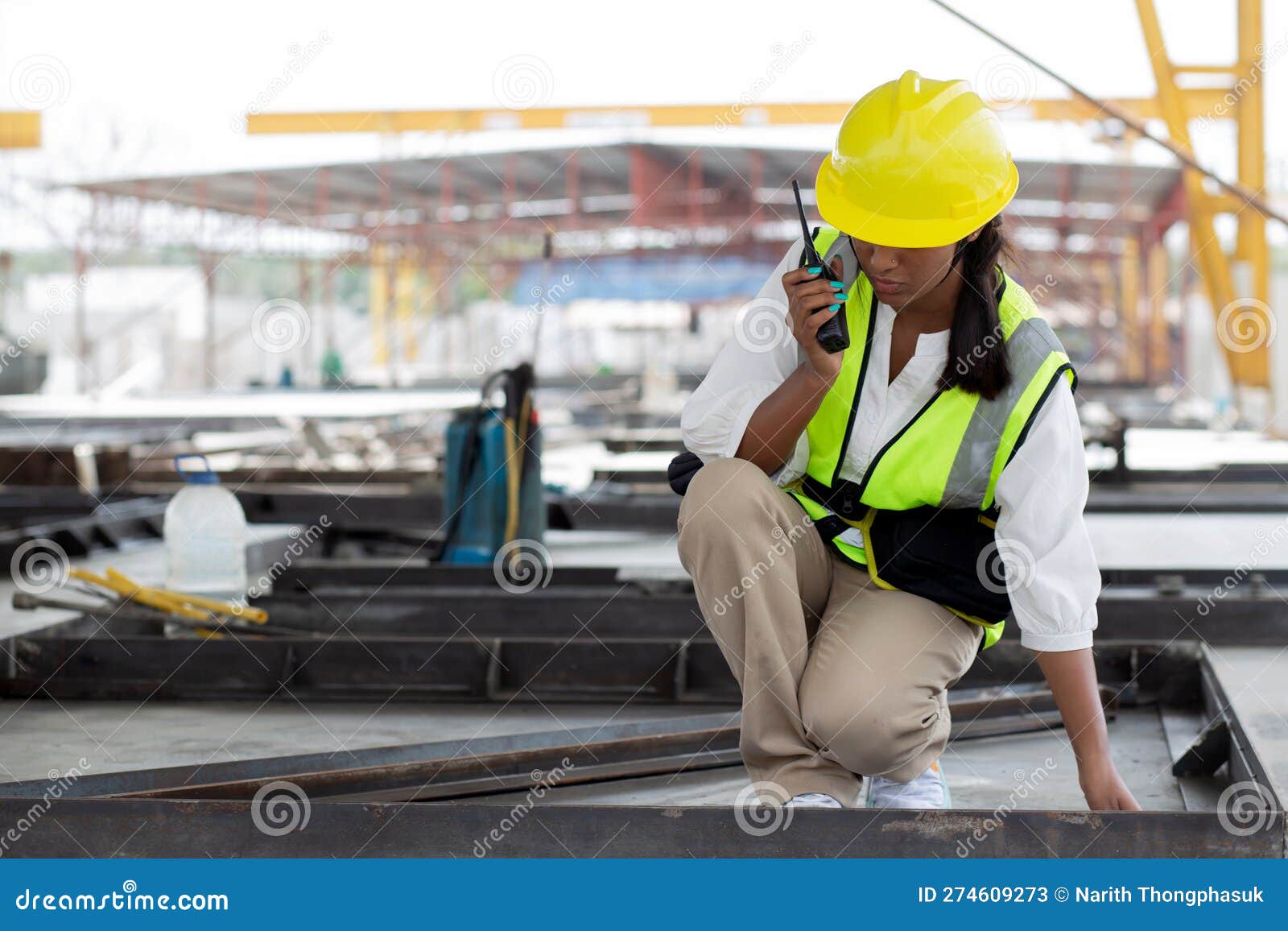 Young Woman Engineer Using Radio Command with Worker in Construction ...