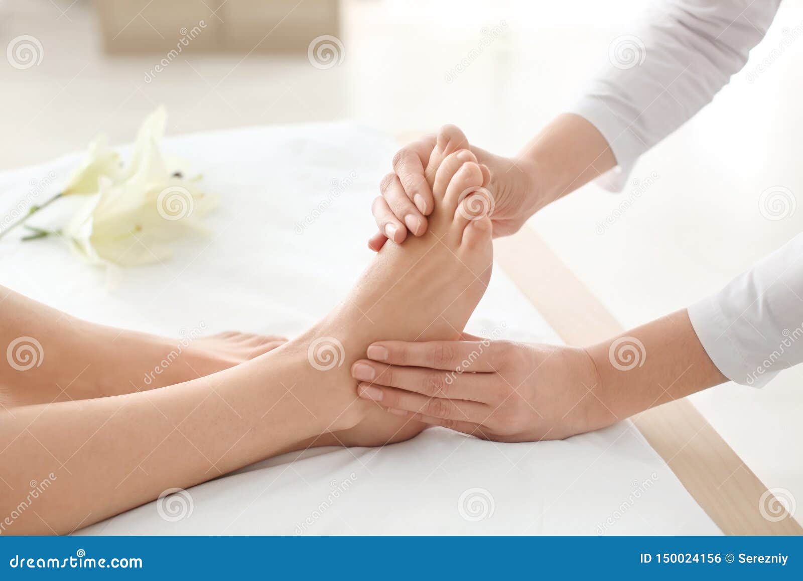 Young Woman Enjoying Foot Massage In Spa Salon Focus On Legs Stock