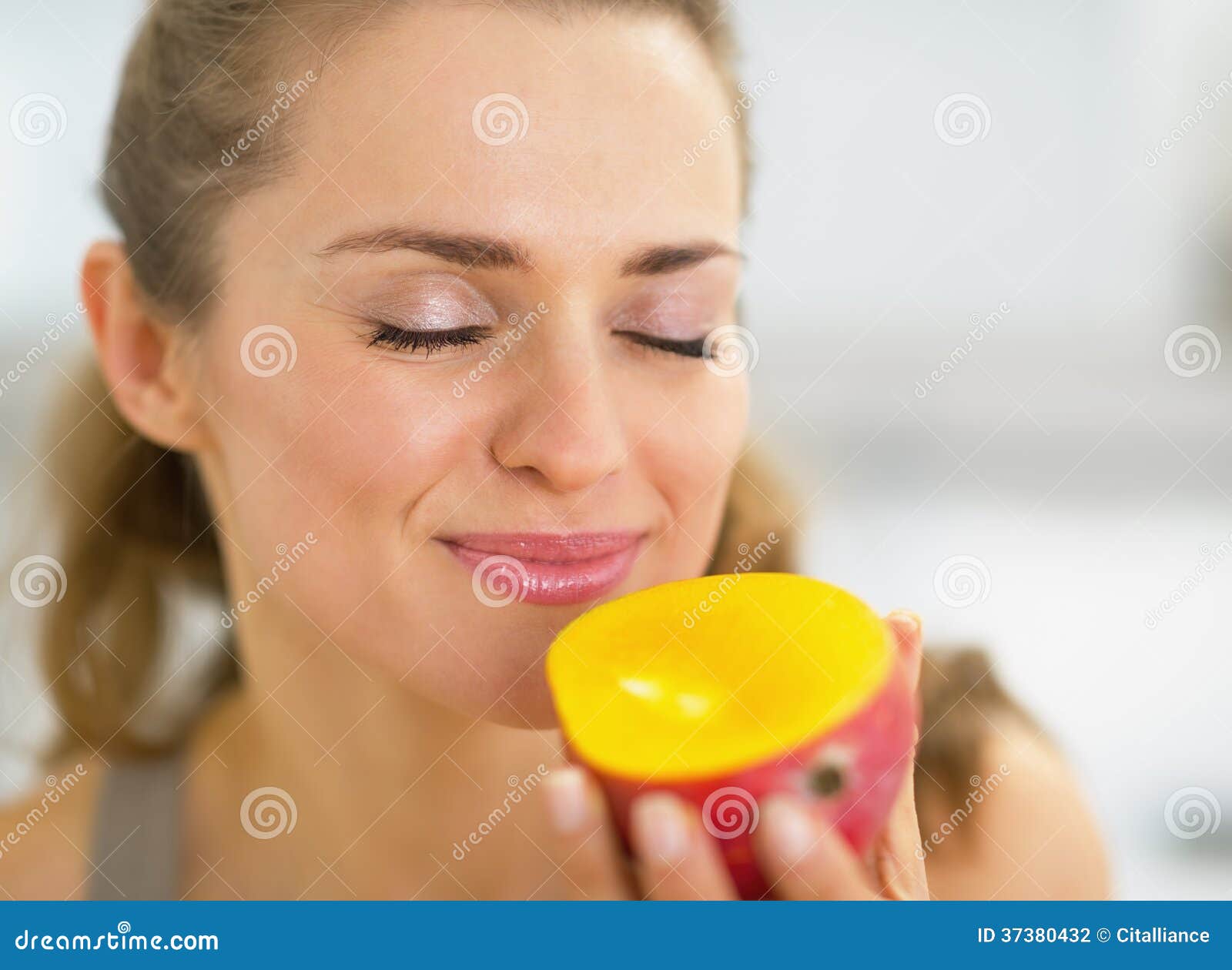 Young woman enjoying mango stock photo. Image of house - 37380432