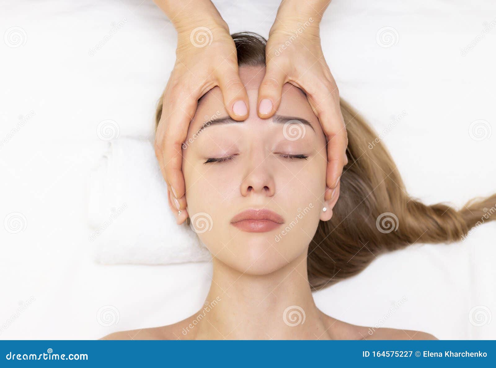 Young Woman Enjoying Massage In Spa Salon Face Massage Closeup Of