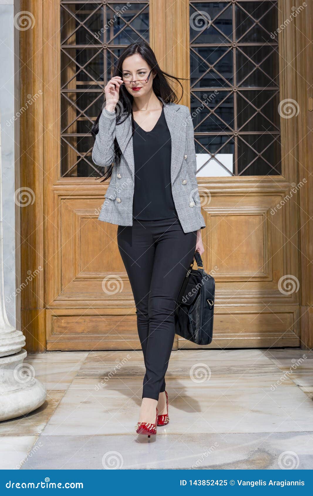 Young Woman Exiting from a Building Stock Image - Image of corporate ...
