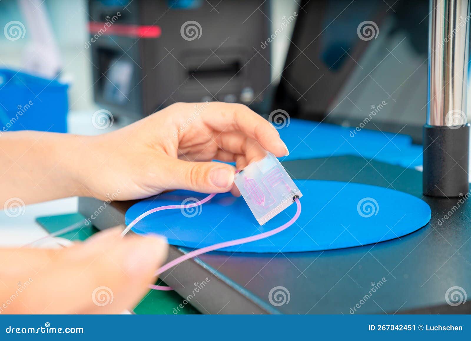 A Young Woman is Experimenting with Lan on Chip Devices. Microfluidics ...
