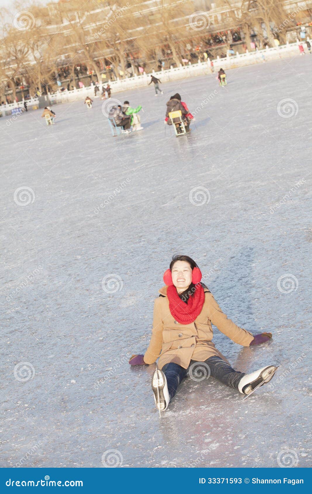 Young Woman Falling while Ice Skating Stock Image - Image of black ...