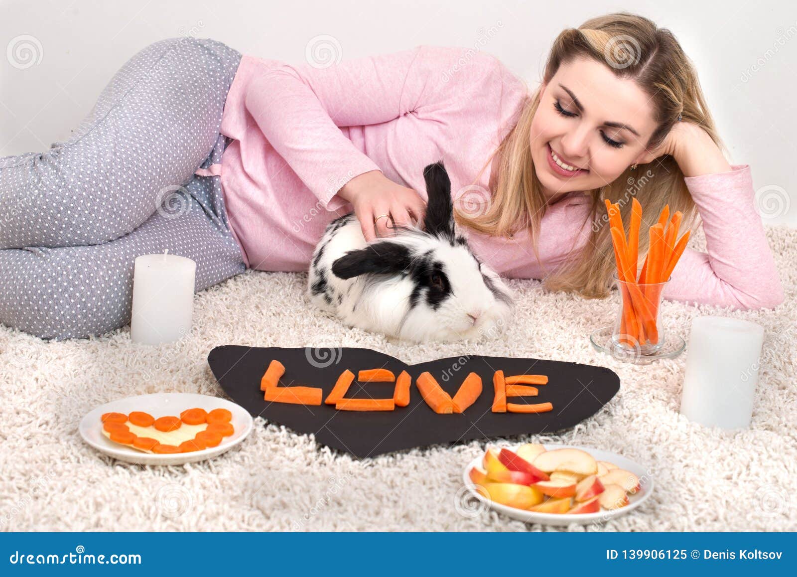 A Young Woman is Feeding Her Beloved Rabbit. Stock Image - Image of ...