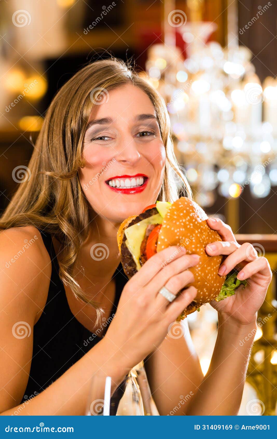 Young Woman in Fine Restaurant, she Eats a Burger Stock Image - Image ...