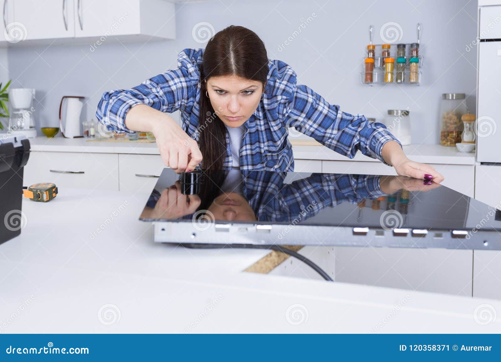 Young woman fixing kitchen stock image. Image of home - 120358371