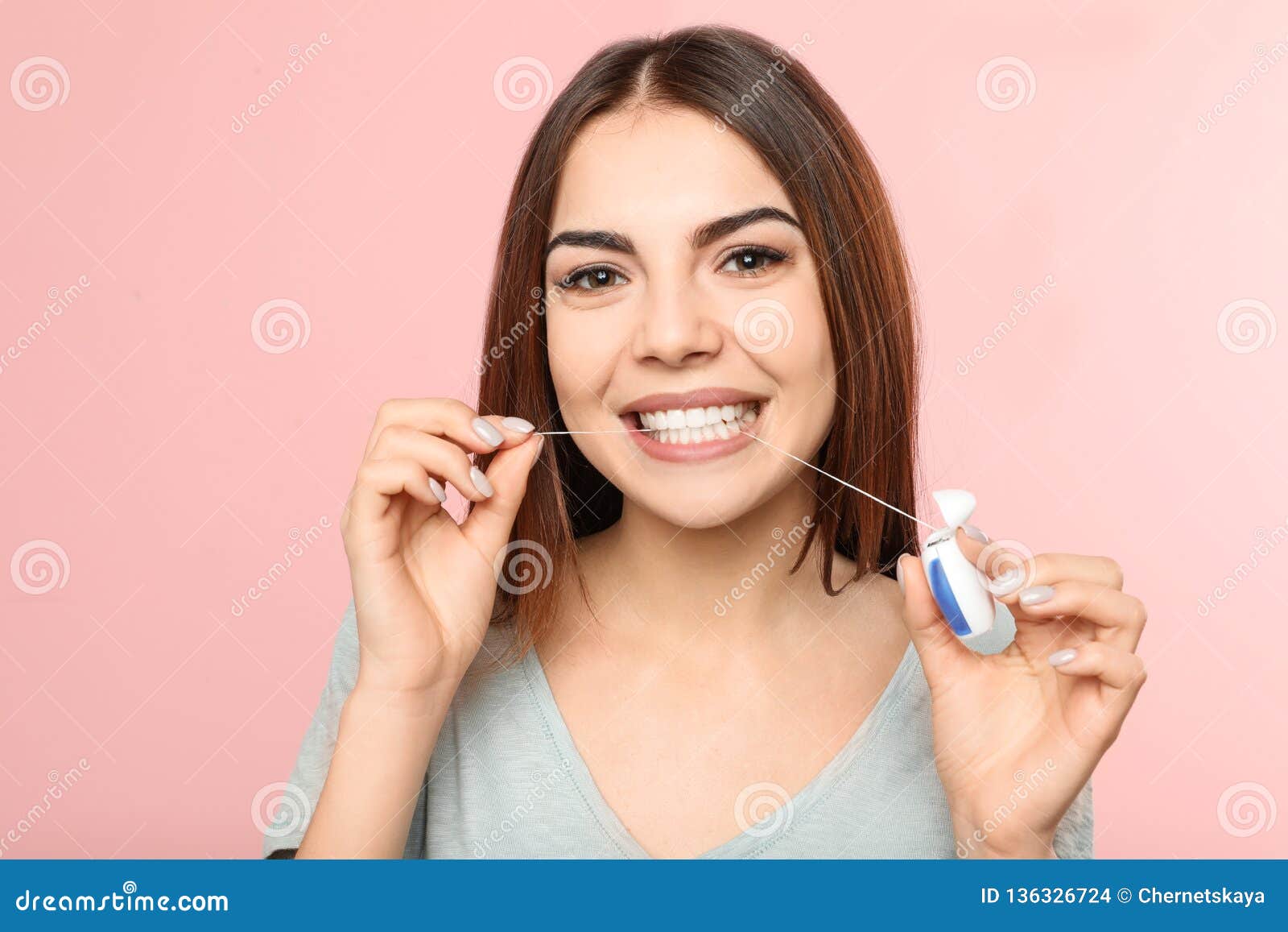 Young woman flossing teeth stock photo. Image of lifestyle - 136326724