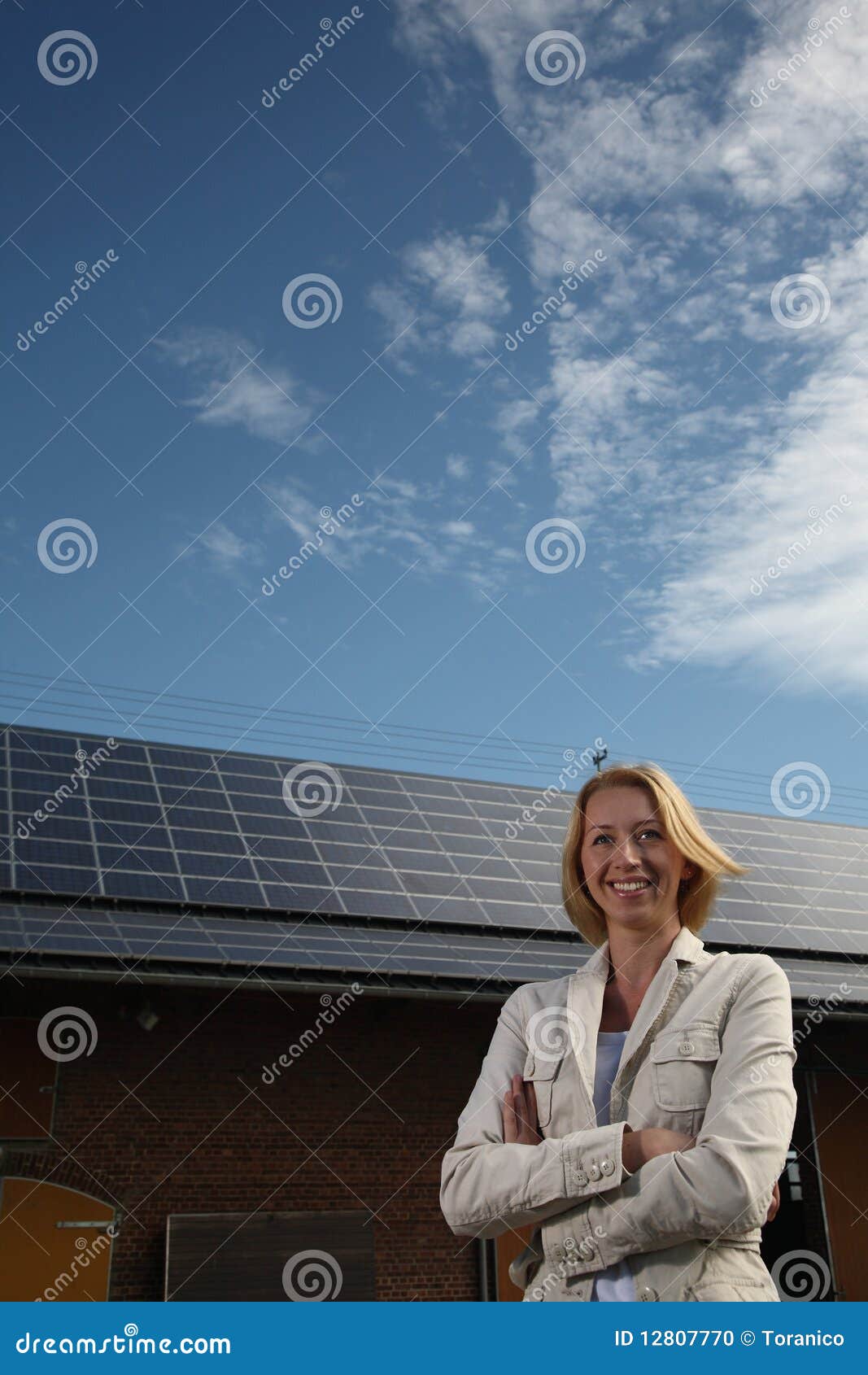 Young Woman in Front of Solar-powered House Stock Photo - Image of ...