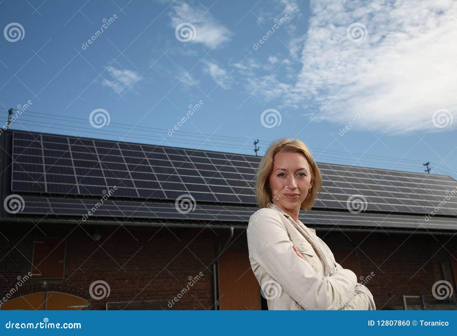 Young Woman in Front of Solar-powered House Stock Photo - Image of ...