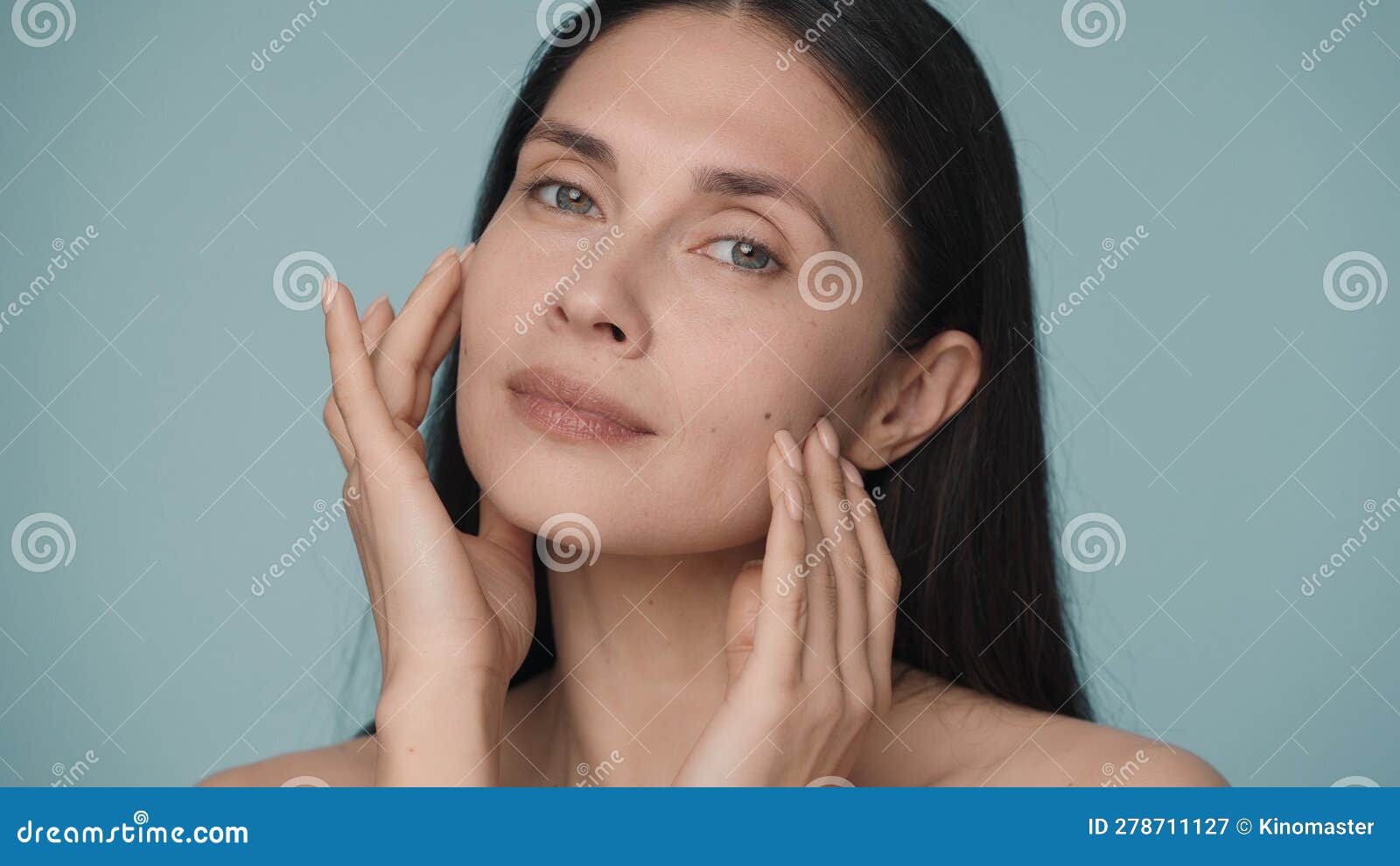 A Young Woman Gently Touches Her Face With Her Fingers Close Up Of A
