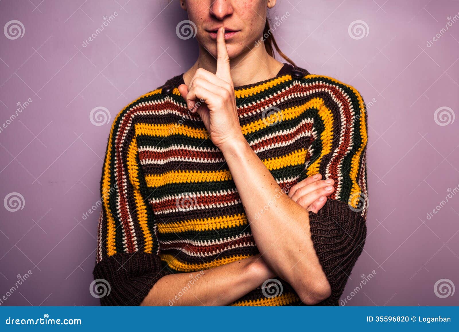Young Woman Gesturing Hush with Her Finger on Her Lip Stock Photo ...
