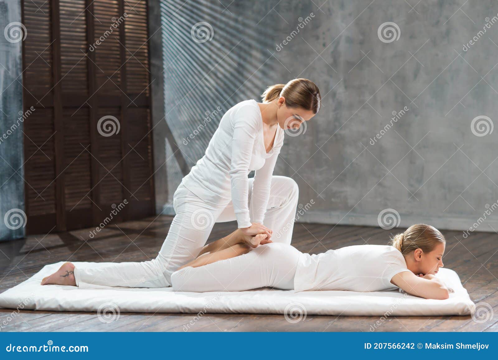 Young Woman Is Getting Thai Massage Treatment By Therapist Traditional