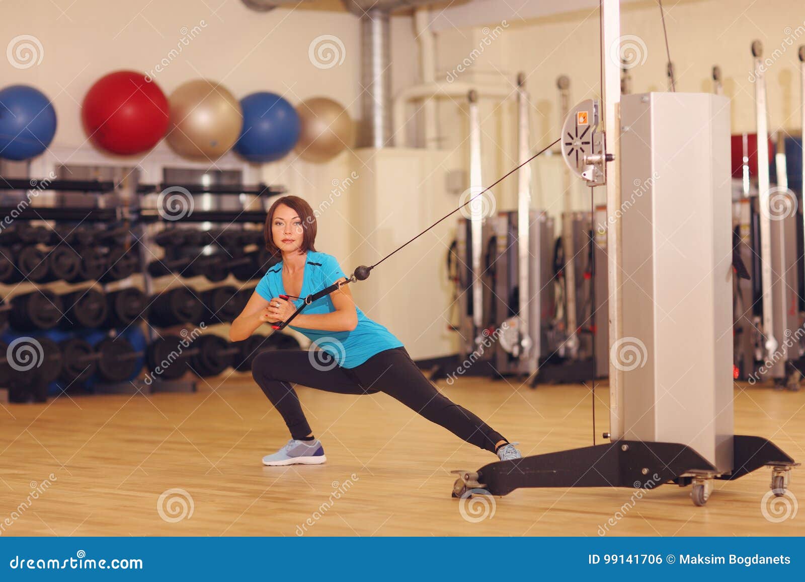 Young Woman at the Gym Exercising on a Machine. Stock Photo - Image of ...