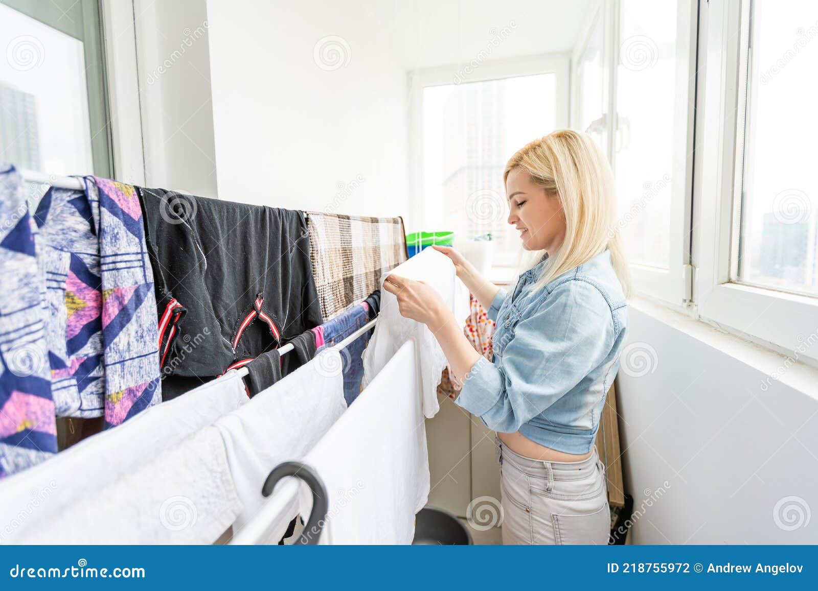 Young Woman Hanging Laundry on the Balcony Stock Photo - Image of ...