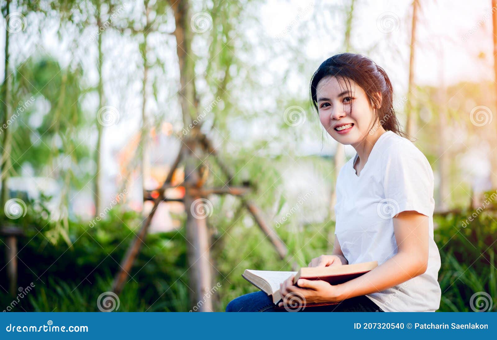 Young Woman Happily Reading the Book Alone Education and Knowledge is a ...