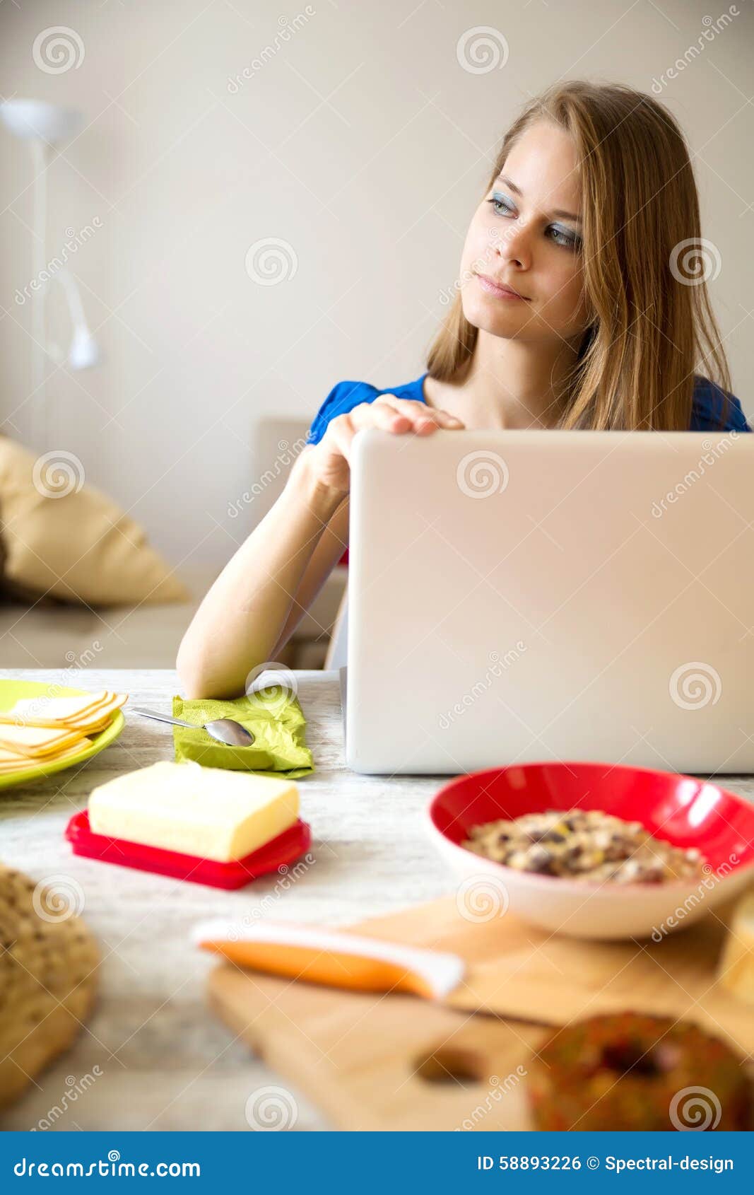 Young Woman Having Breakfast while Using a Laptop Computer Stock Photo ...