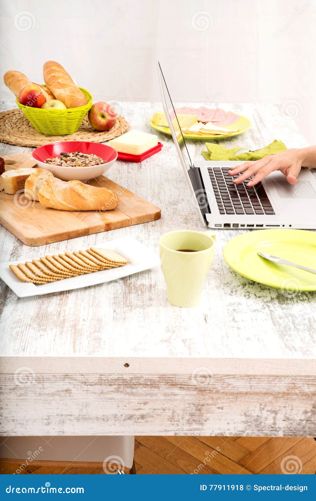 Young Woman Having Breakfast while Using a Laptop Computer Stock Photo ...