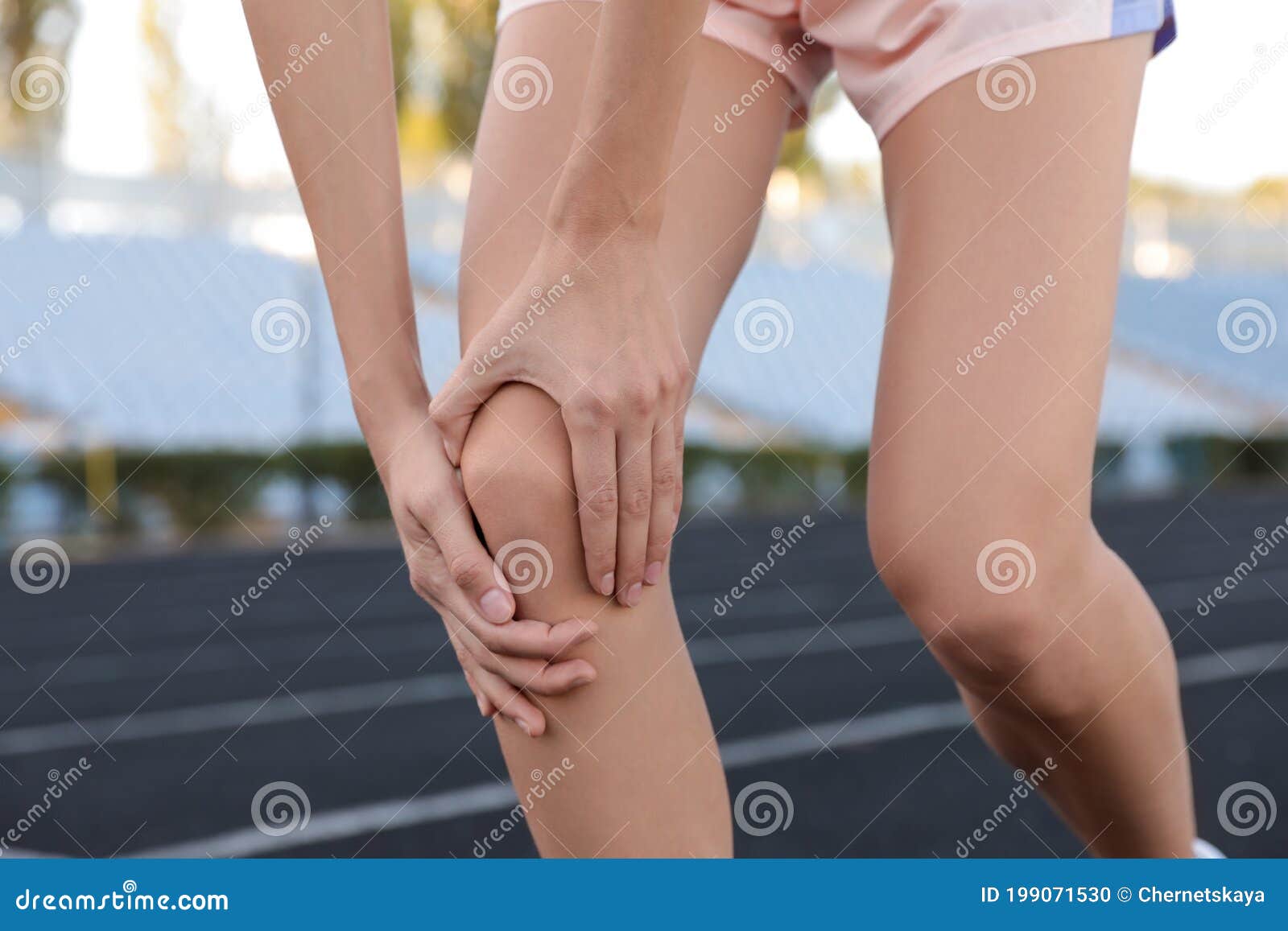 Young Woman Having Knee Problems at Stadium, Closeup Stock Photo ...