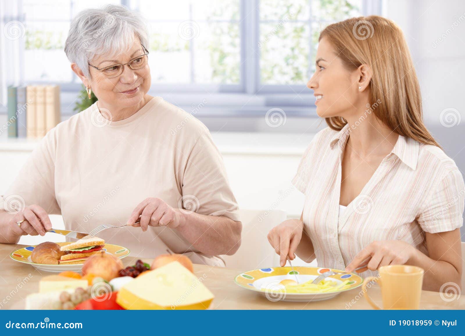 Young Woman Having Lunch with Mother Smiling Stock Image - Image of ...