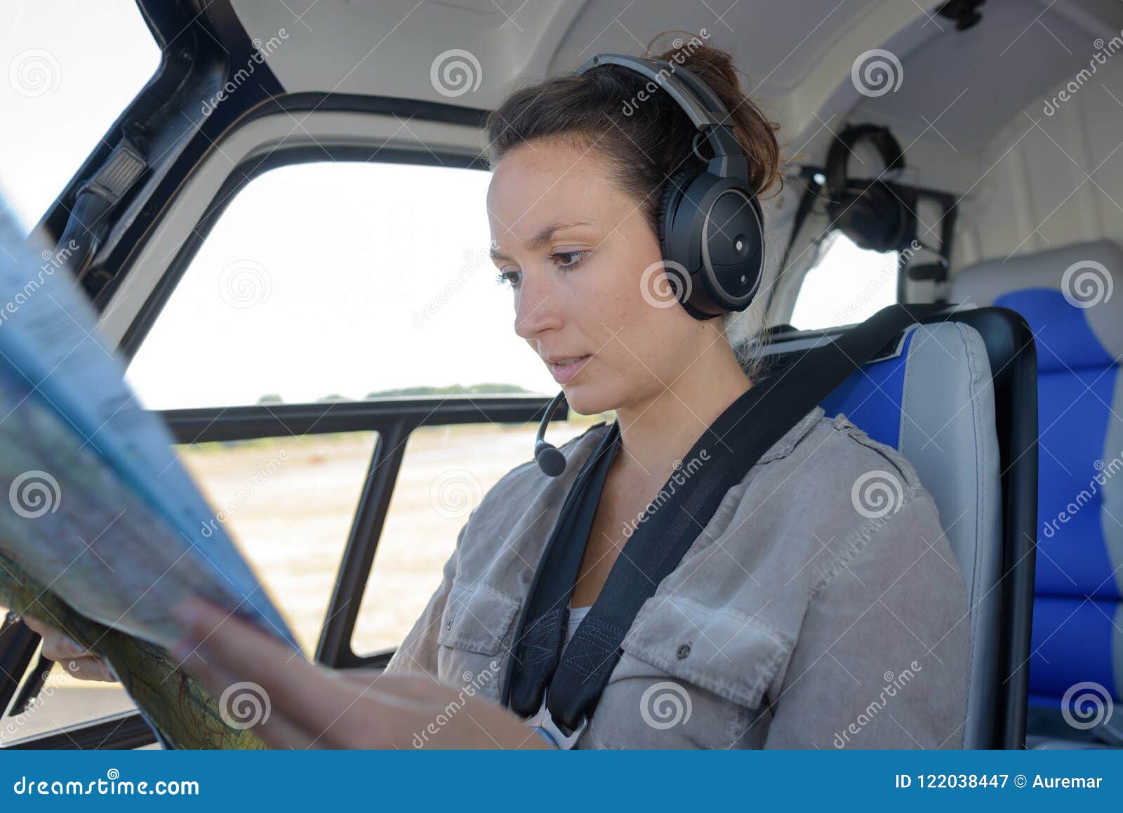 Young Woman Helicopter Pilot Reading Map Stock Image - Image of cockpit ...