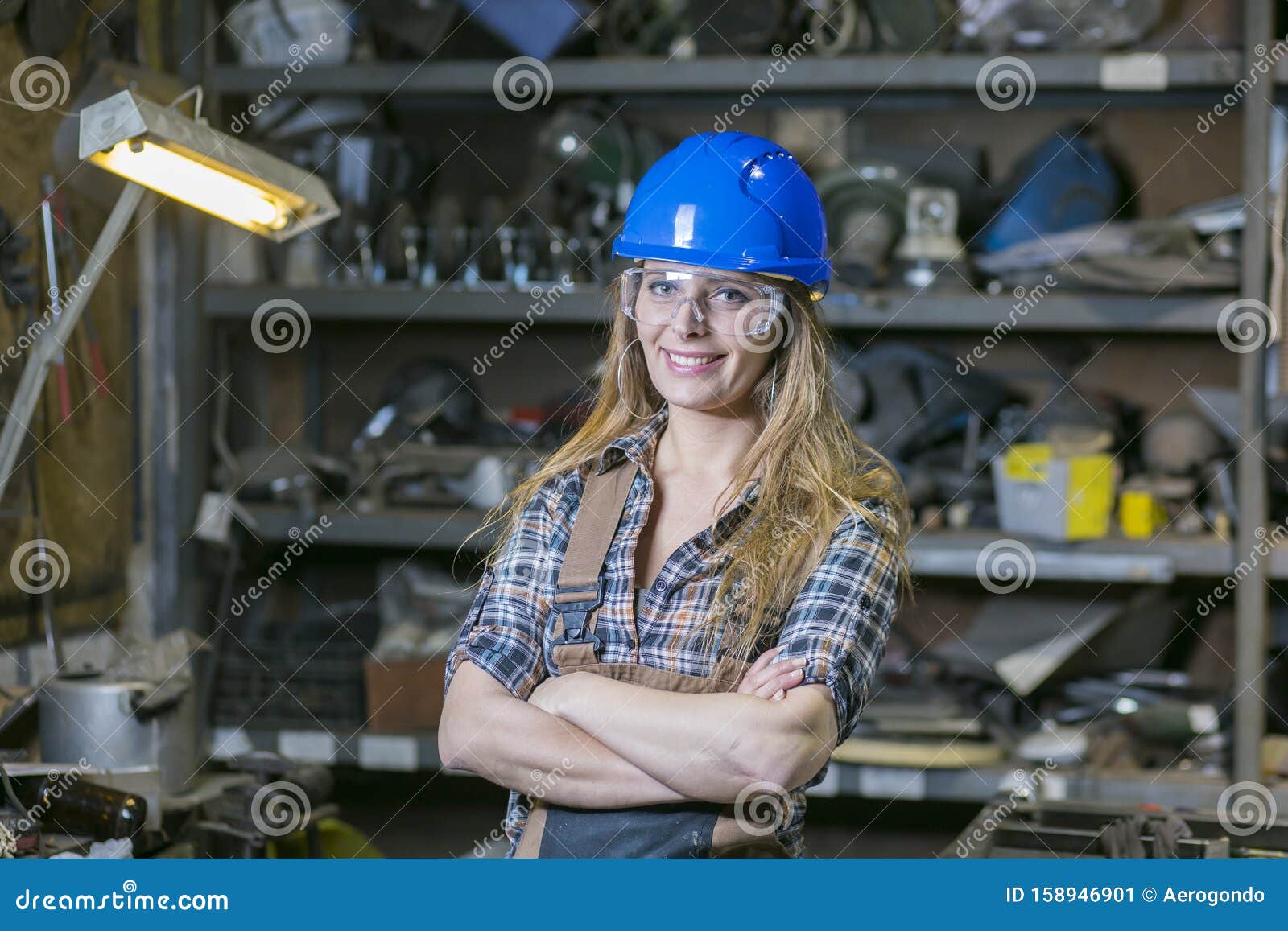 Young Woman with a Helmet Posing in a Workshop Stock Image - Image of ...