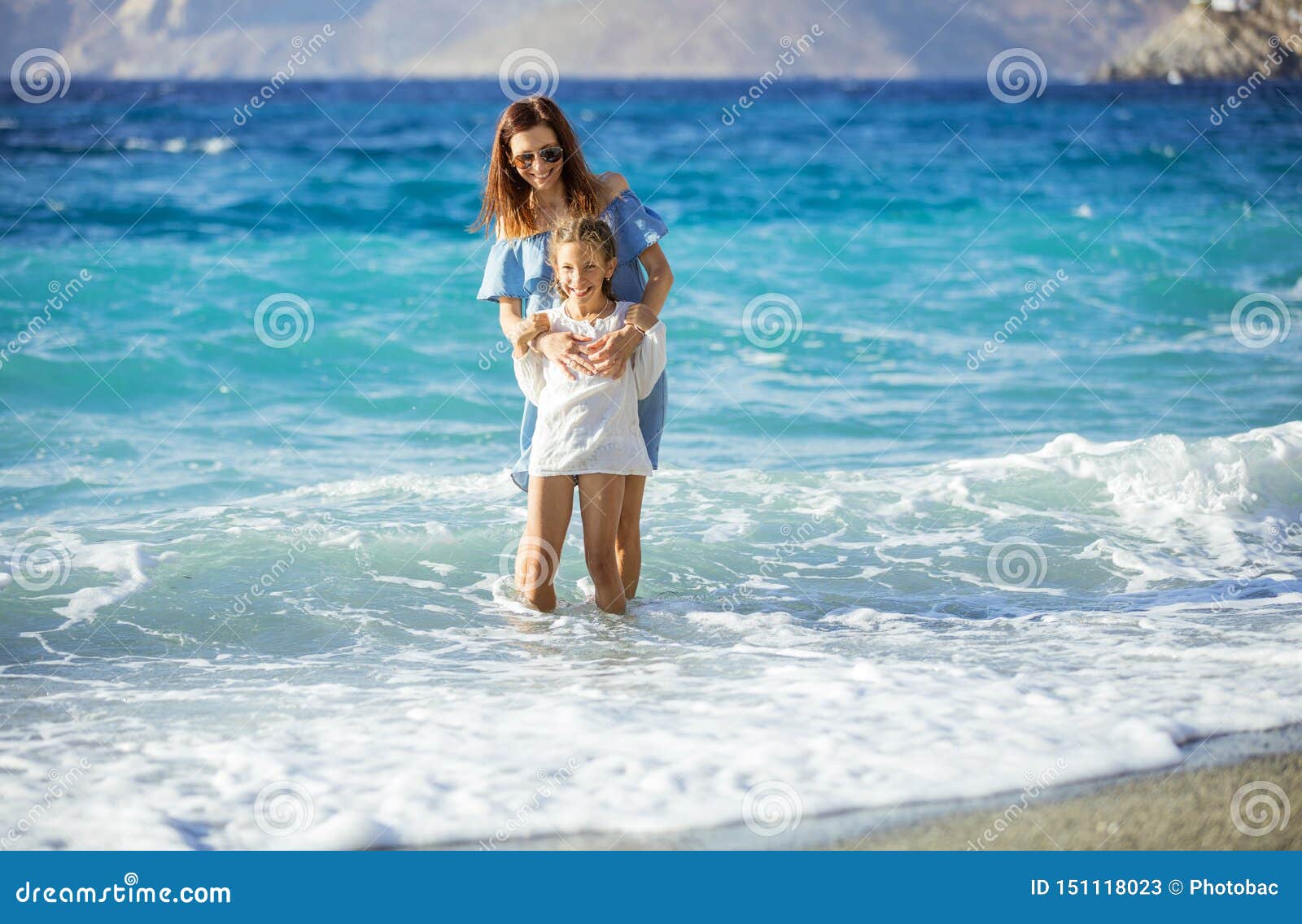Young Woman And Her Daughter Enjoying Summer Day On Beach Stock Image