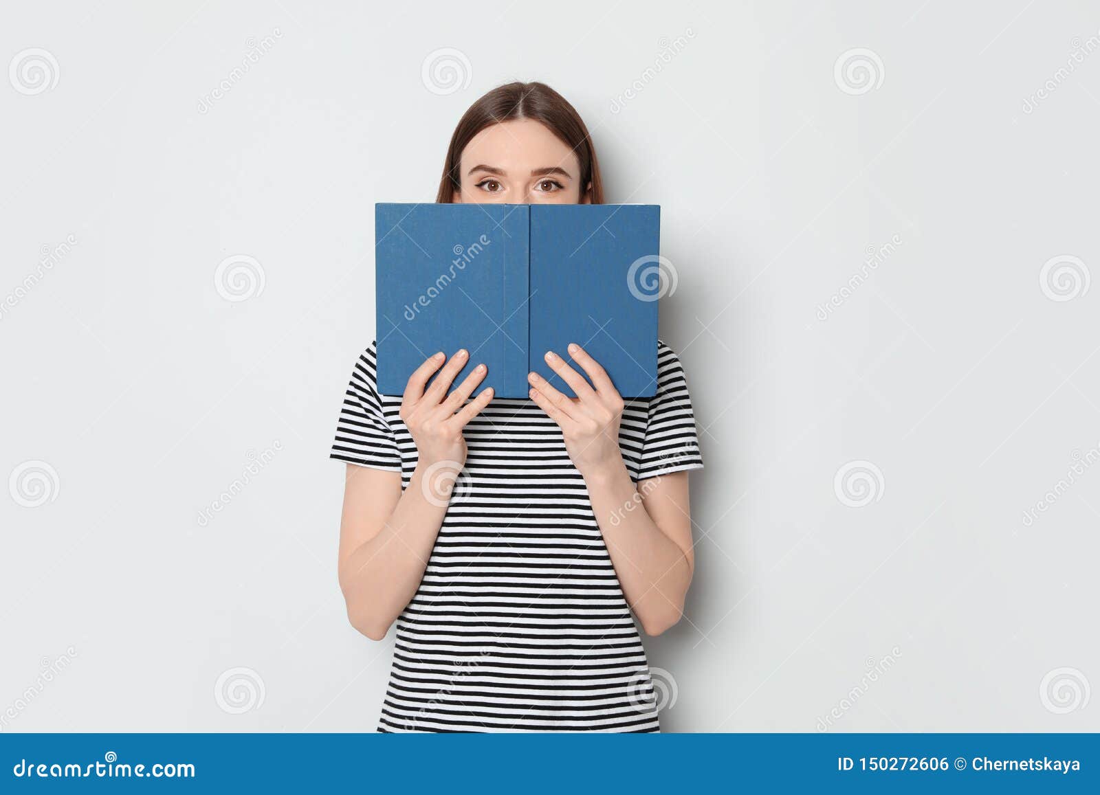 Young Woman Hiding Behind Book on White Background. Reading Activity ...
