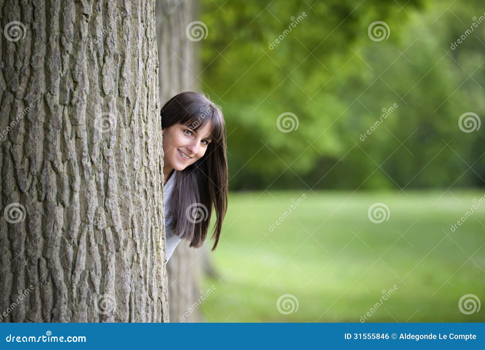 Young Woman Hiding Behind a Tree Stock Photo - Image of lifestyle ...