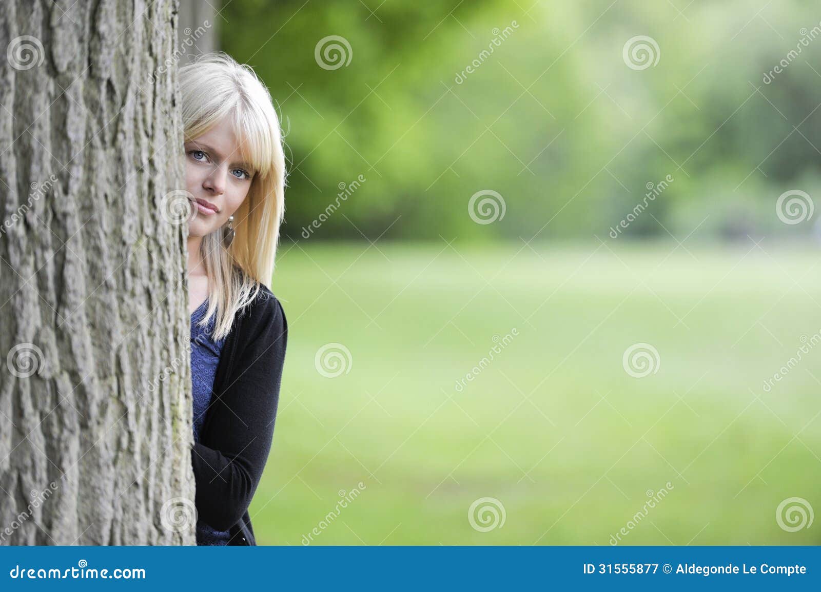 Young Woman Hiding Behind a Tree Stock Image - Image of outside, adult ...