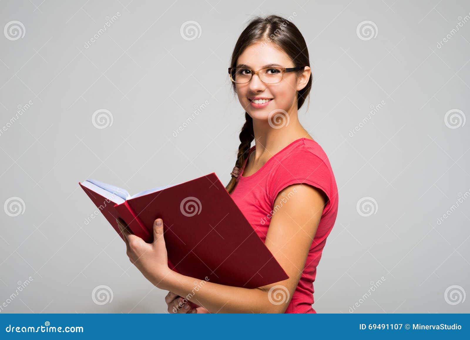 Young woman holding a book stock image. Image of college - 69491107