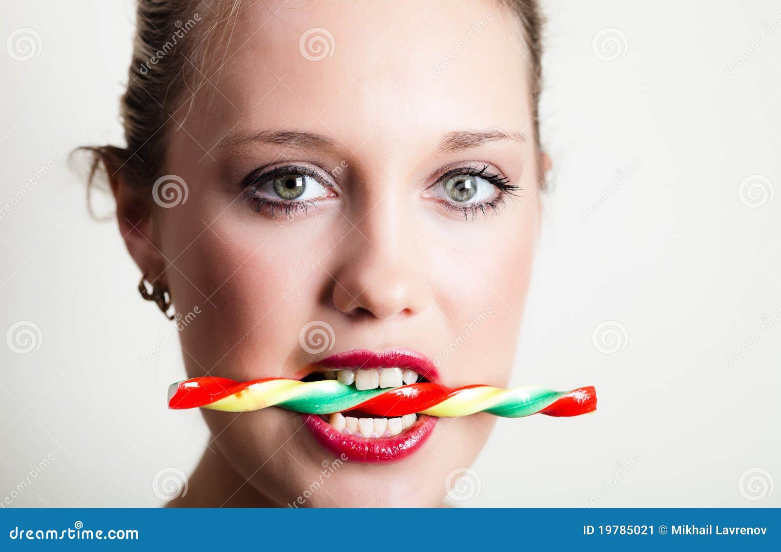 Young Woman Holding Candy in Her Teeth Stock Image - Image of teeth ...