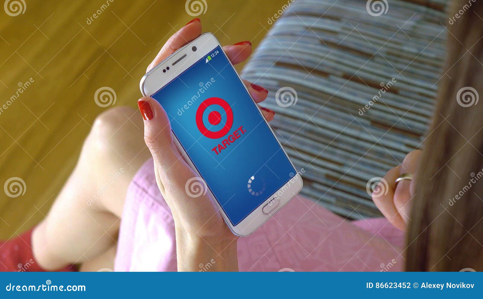 Young Woman Holding a Cell Phone with Loading Target Mobile App ...
