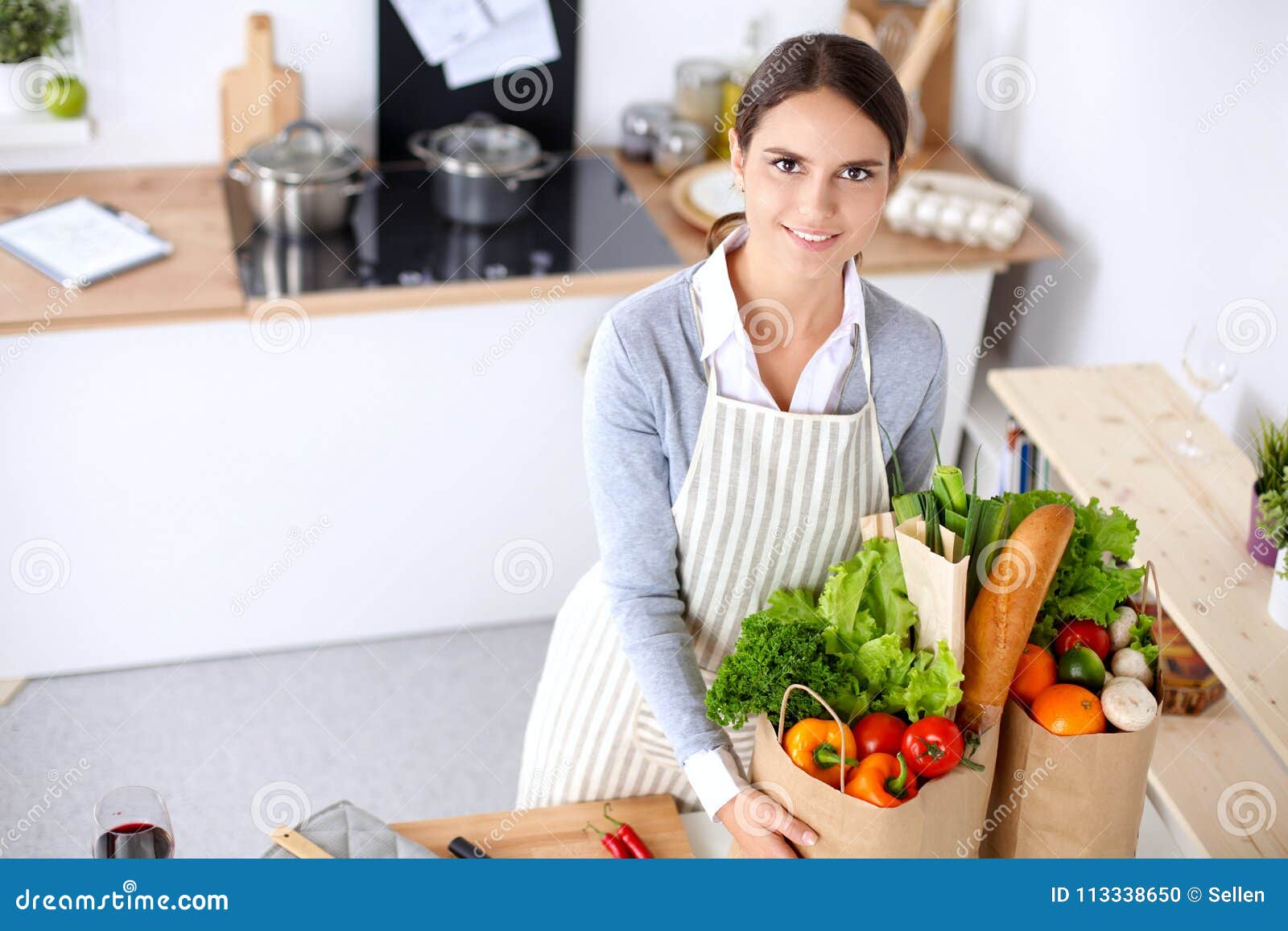 Young Woman Holding Grocery Shopping Bag with Vegetables . Standing in ... Young Woman Holding Grocery Shopping Bag with Vegetables . Standing in ...