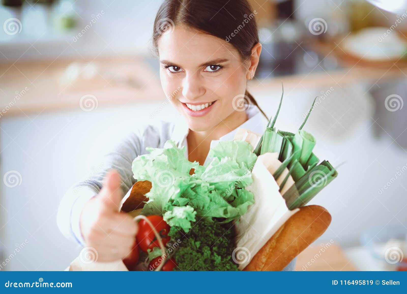 Young Woman Holding Grocery Shopping Bag with Vegetables . Standing in ... Young Woman Holding Grocery Shopping Bag with Vegetables . Standing in ...