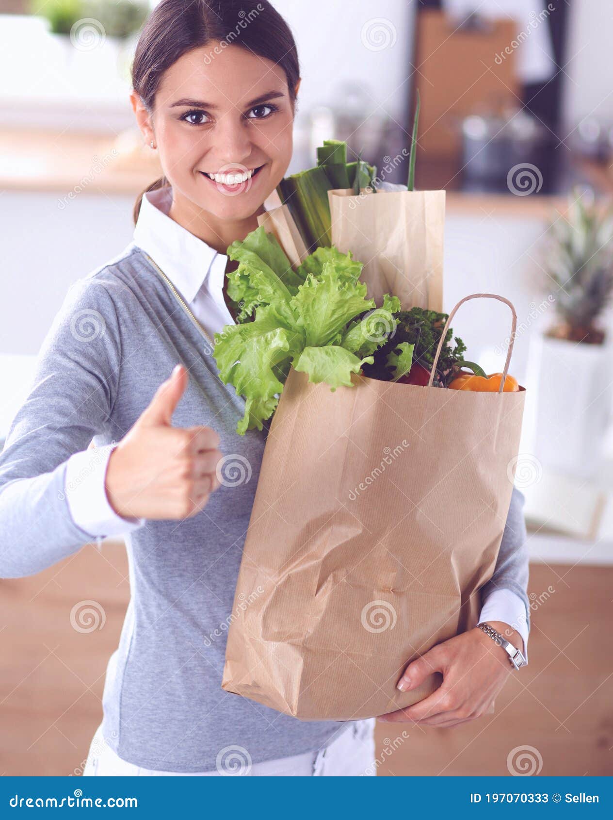 Young Woman Holding Grocery Shopping Bag with Vegetables .Standing in ... Young Woman Holding Grocery Shopping Bag with Vegetables .Standing in ...