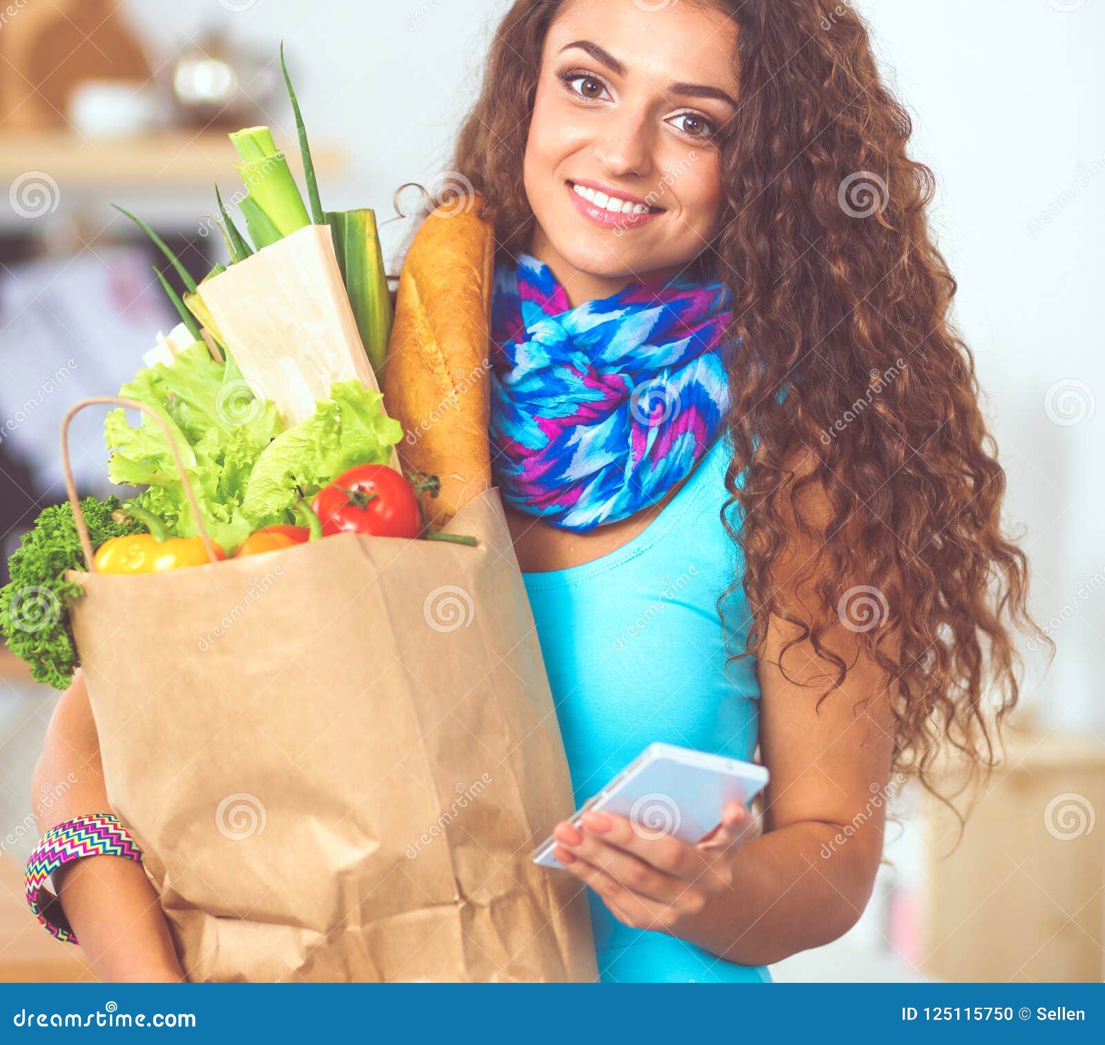 Young Woman Holding Grocery Shopping Bag with Vegetables Standing in ... Young Woman Holding Grocery Shopping Bag with Vegetables Standing in ...