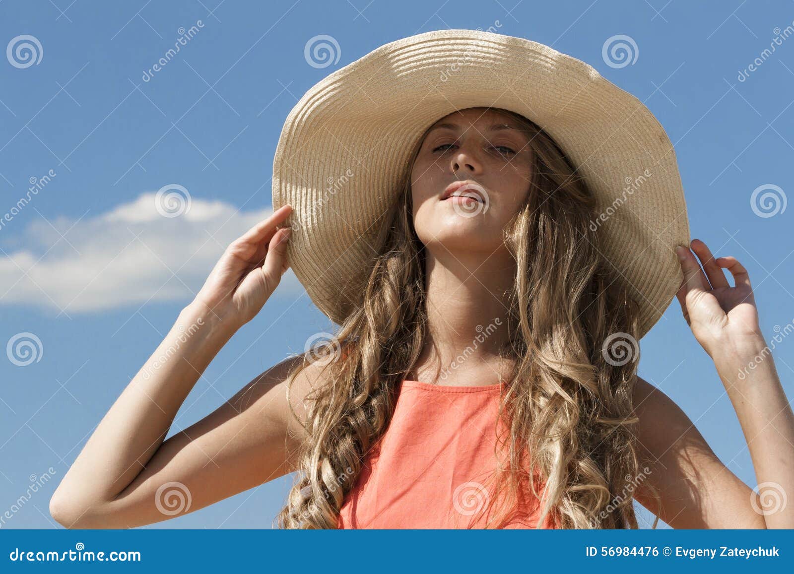 Young Woman Holding Her Hat with Two Hands Stock Photo - Image of blue ... Young Woman Holding Her Hat with Two Hands Stock Photo - Image of blue ...