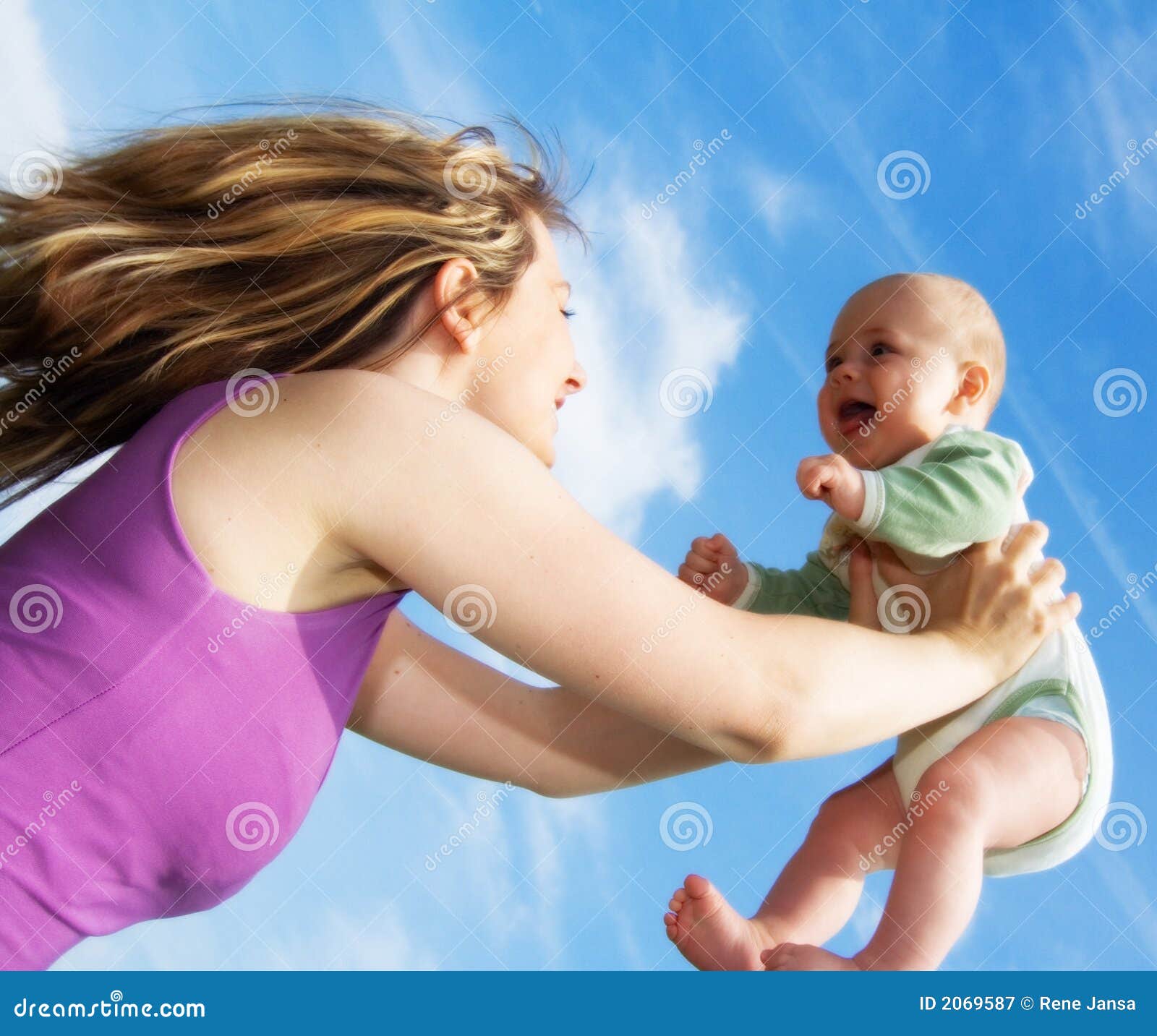 Young Woman Holding Up Baby Stock Image - Image of holds, purple: 2069587