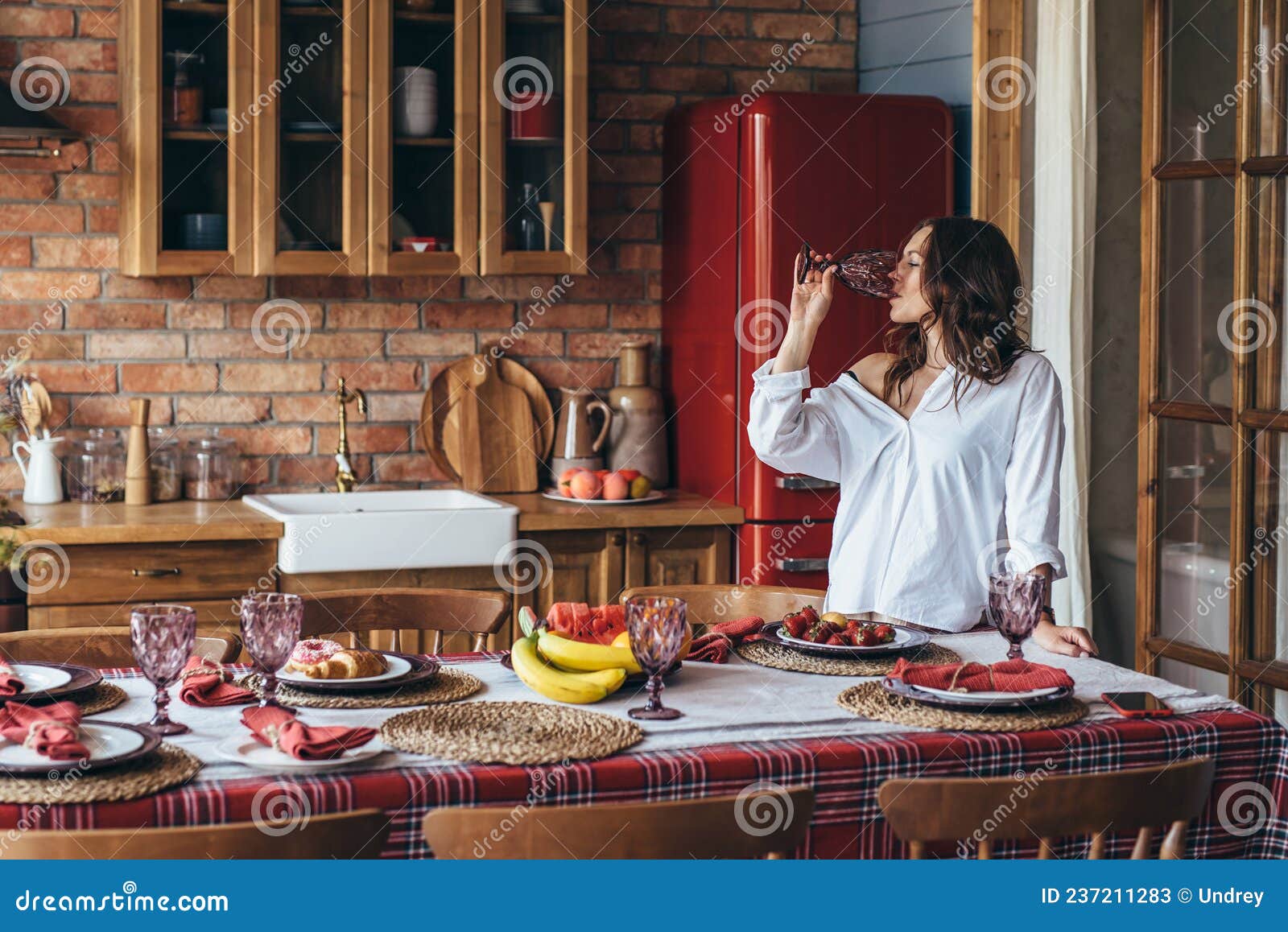 Young Woman at Home in the Kitchen Drinking Water from Glass. Stock ...