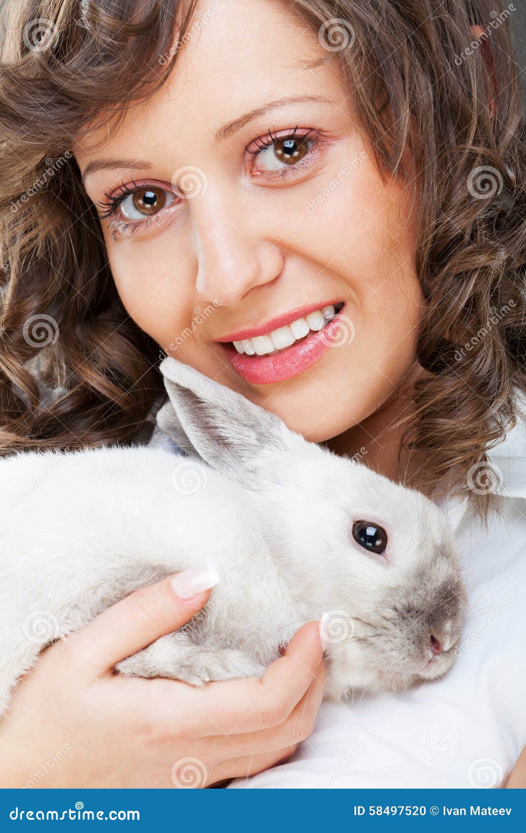 Young woman hugging rabbit stock photo. Image of curly - 58497520