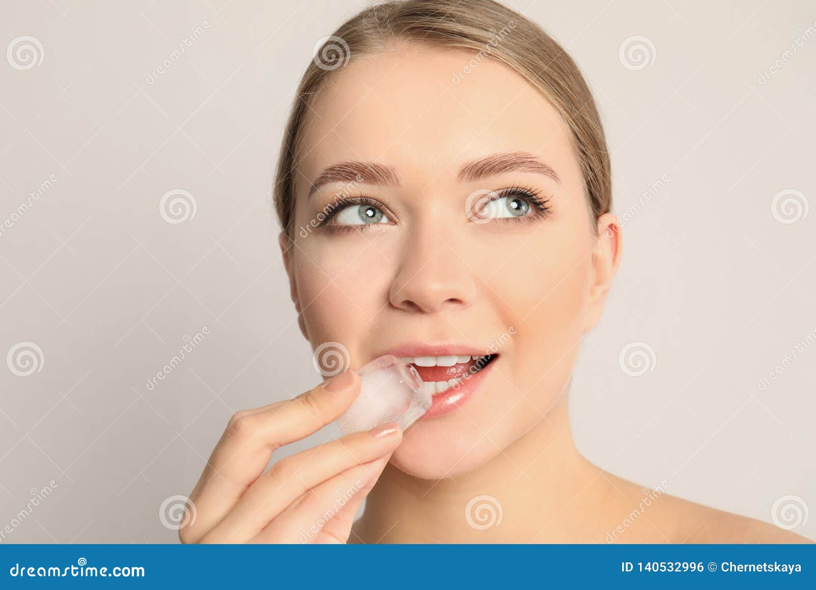 Young woman with ice cube stock photo. Image of hand - 140532996