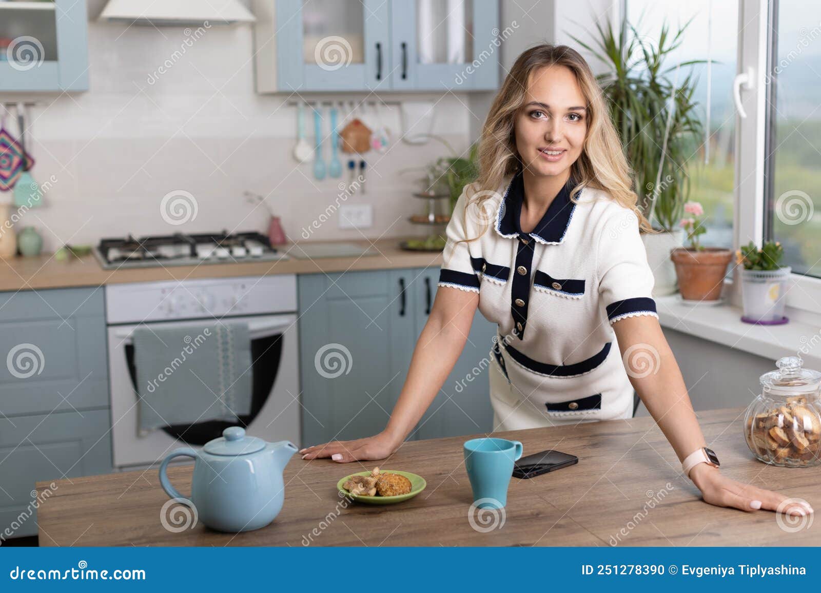 Young woman in the kitchen stock photo. Image of food - 251278390