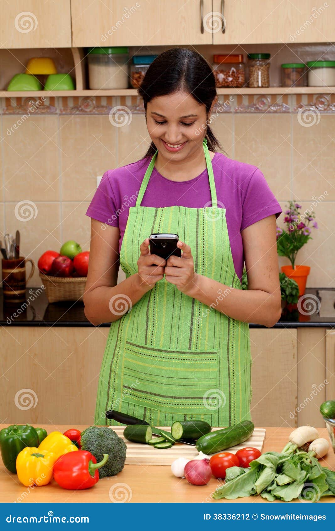 Young Woman in Kitchen and Texting Stock Photo - Image of indian ...