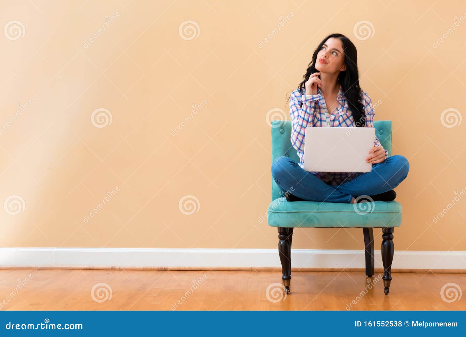 Young Woman with a Laptop Computer in a Thoughtful Pose Stock Photo ...