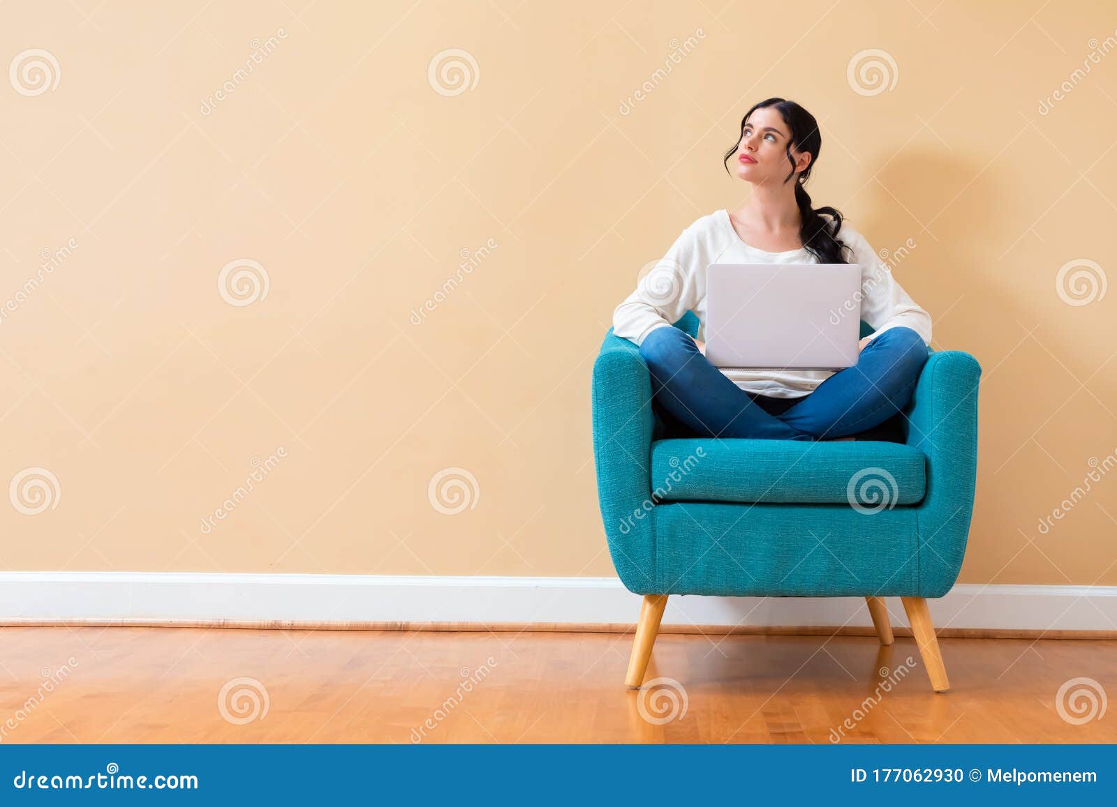 Young Woman with a Laptop Computer in a Thoughtful Pose Stock Photo ...