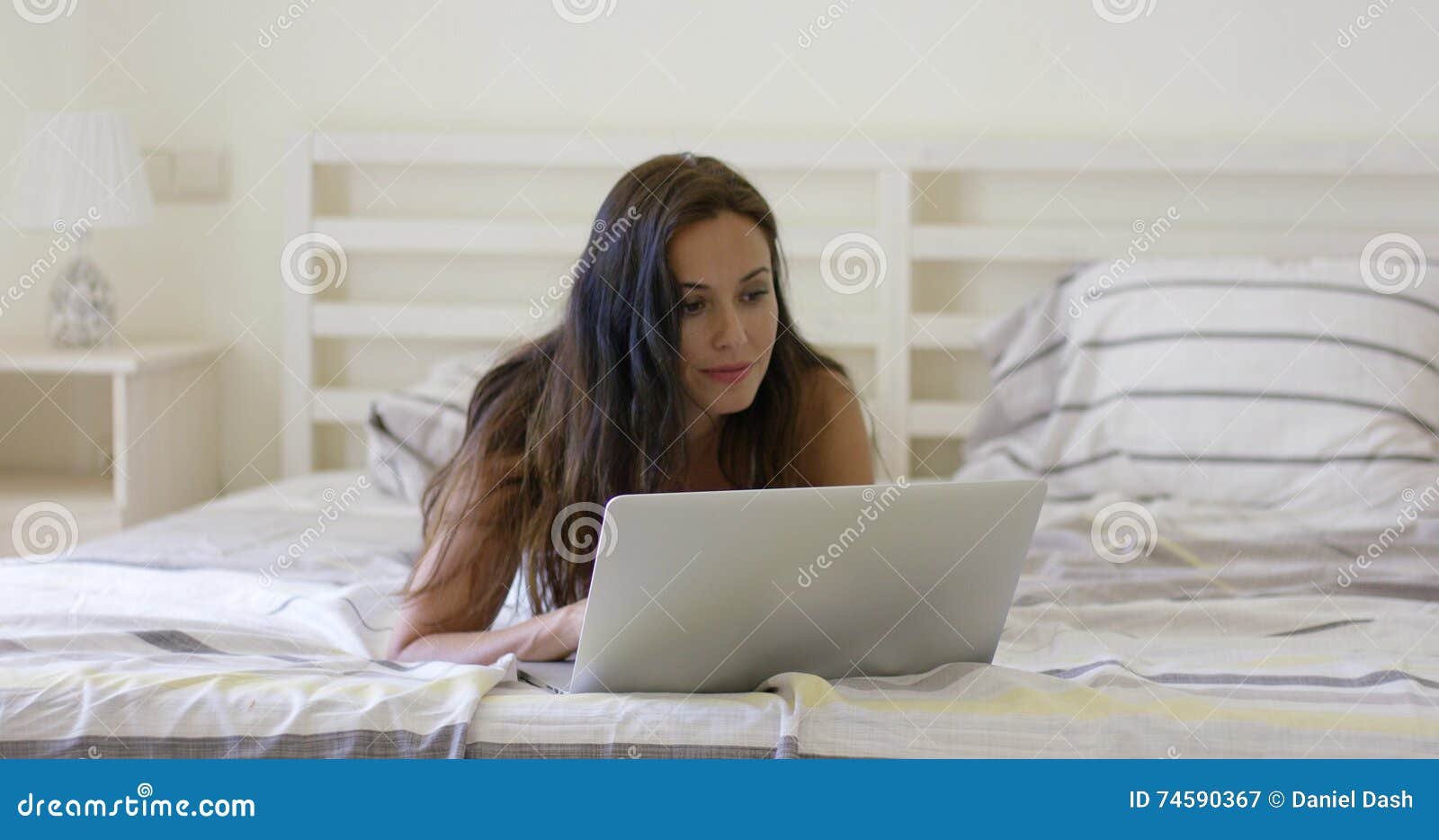 Young Woman Laying Down in Bed Using Laptop Stock Image - Image of home ...