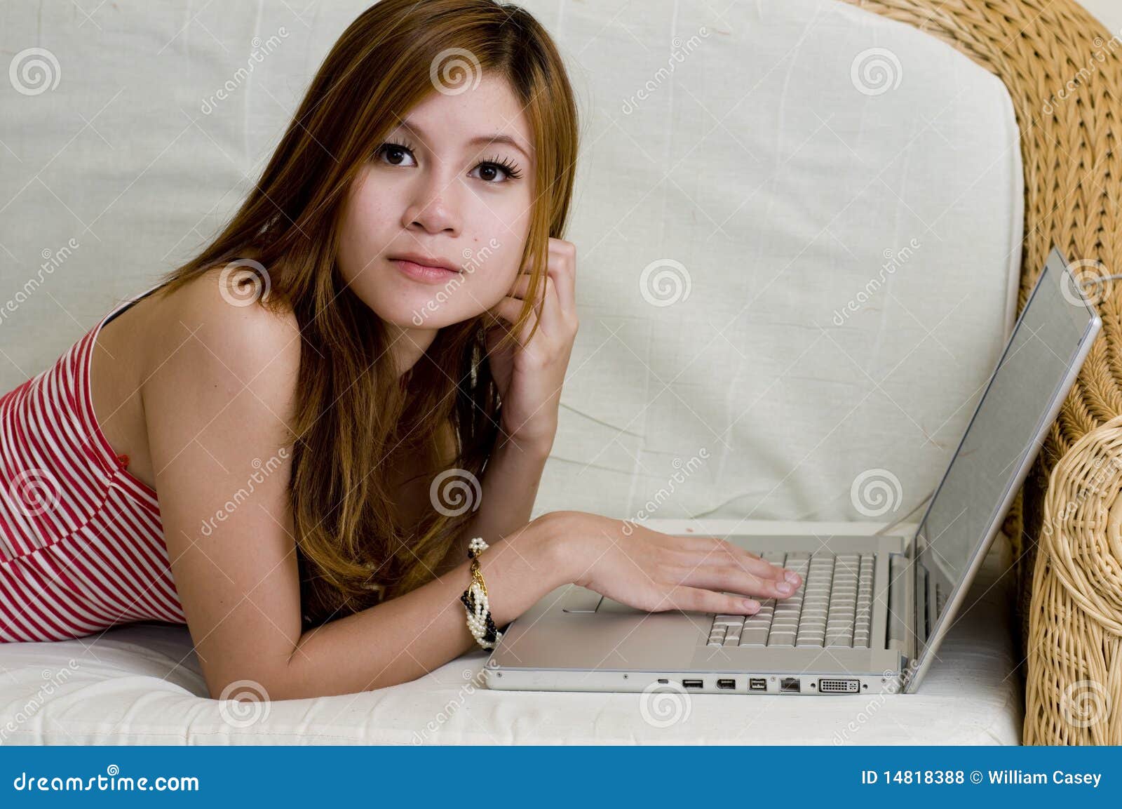 Young Woman Laying Down with Computer Stock Photo - Image of ...